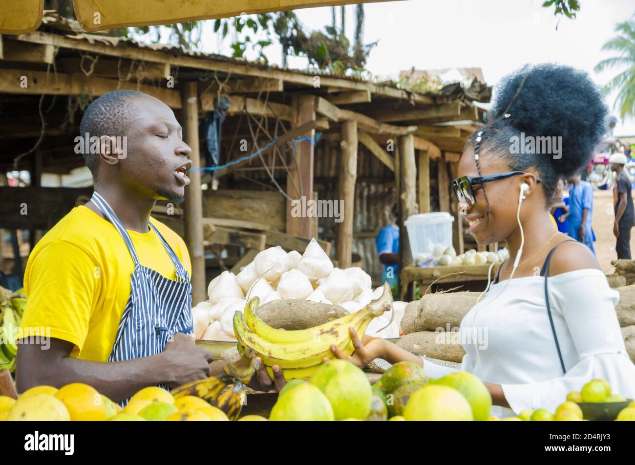 Young African market man feeling excited as he sells his goods to his ...