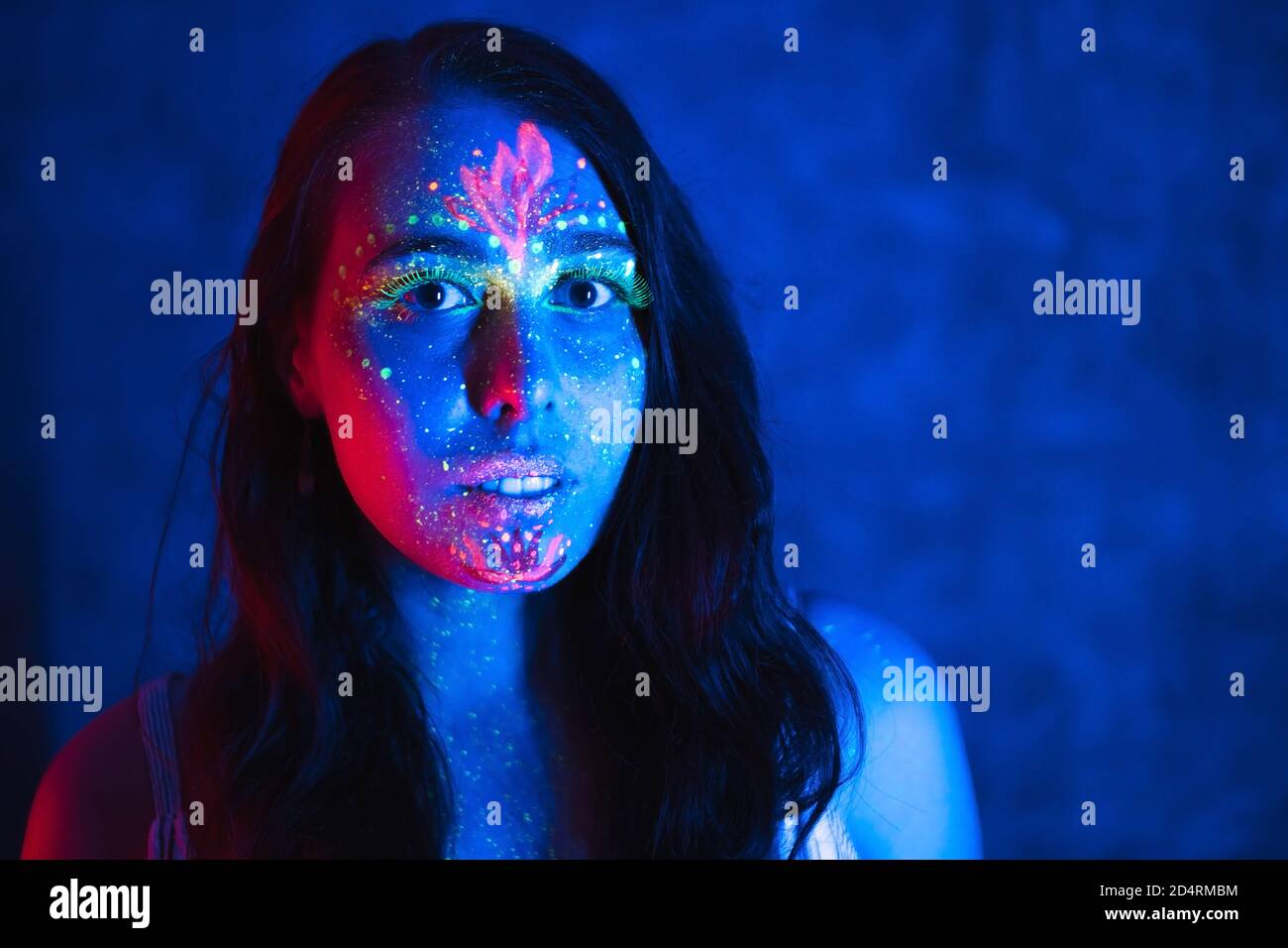 Body art on woman glowing in ultraviolet light. Art and sensuality ...