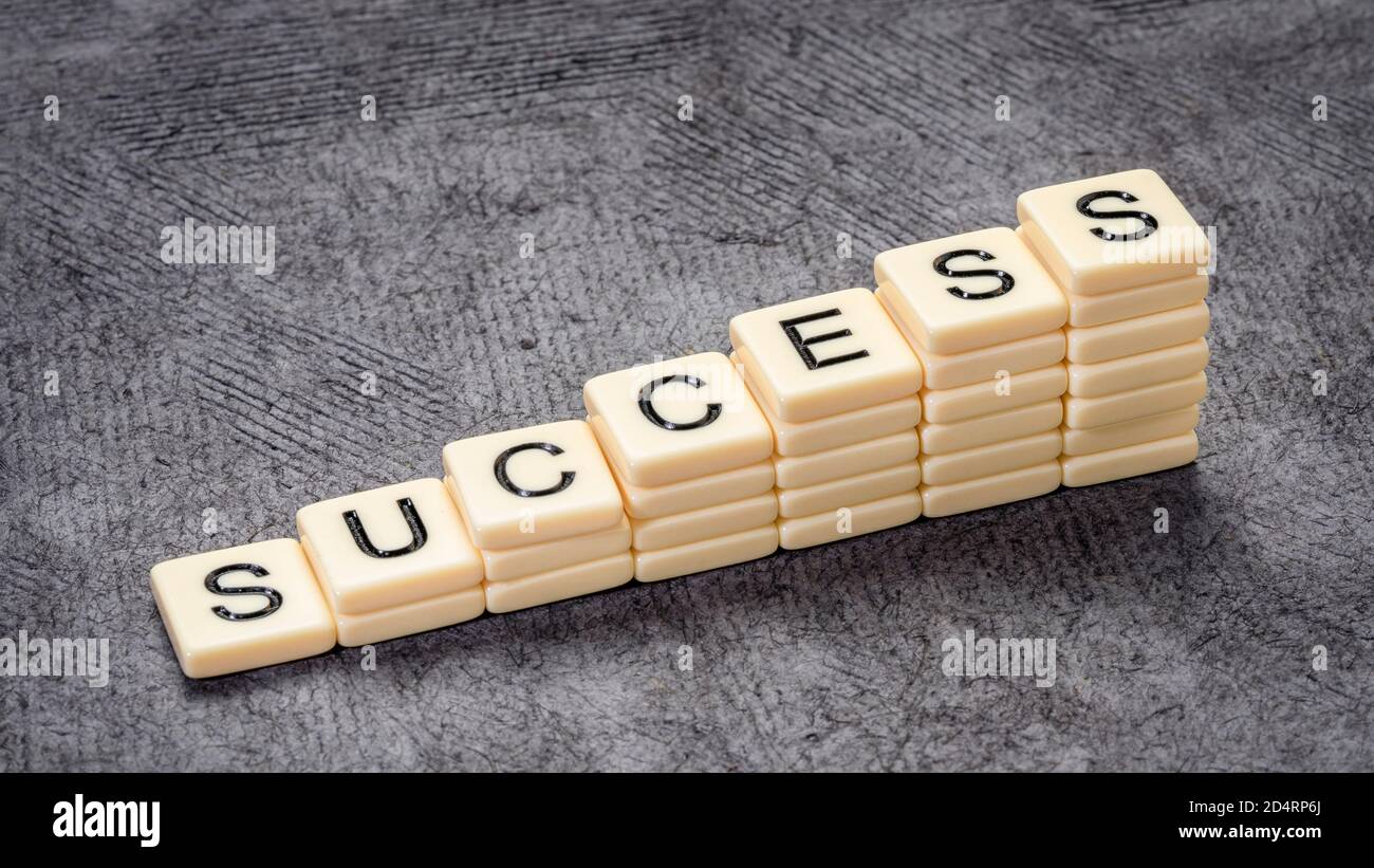 success word abstract in ivory letters against textured handmade paper ...