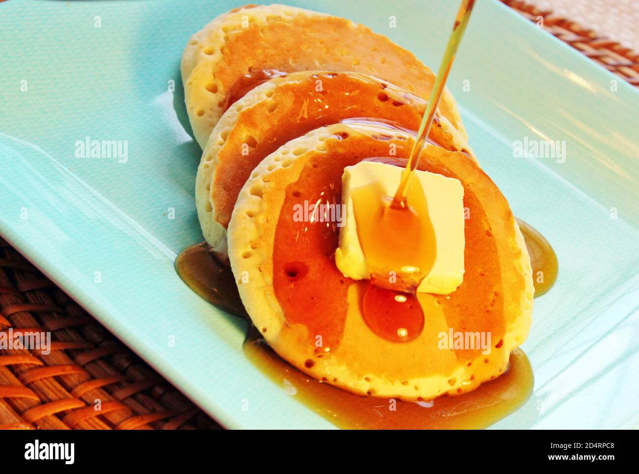 Cooked pancakes with a pat of butter and syrup Stock Photo - Alamy