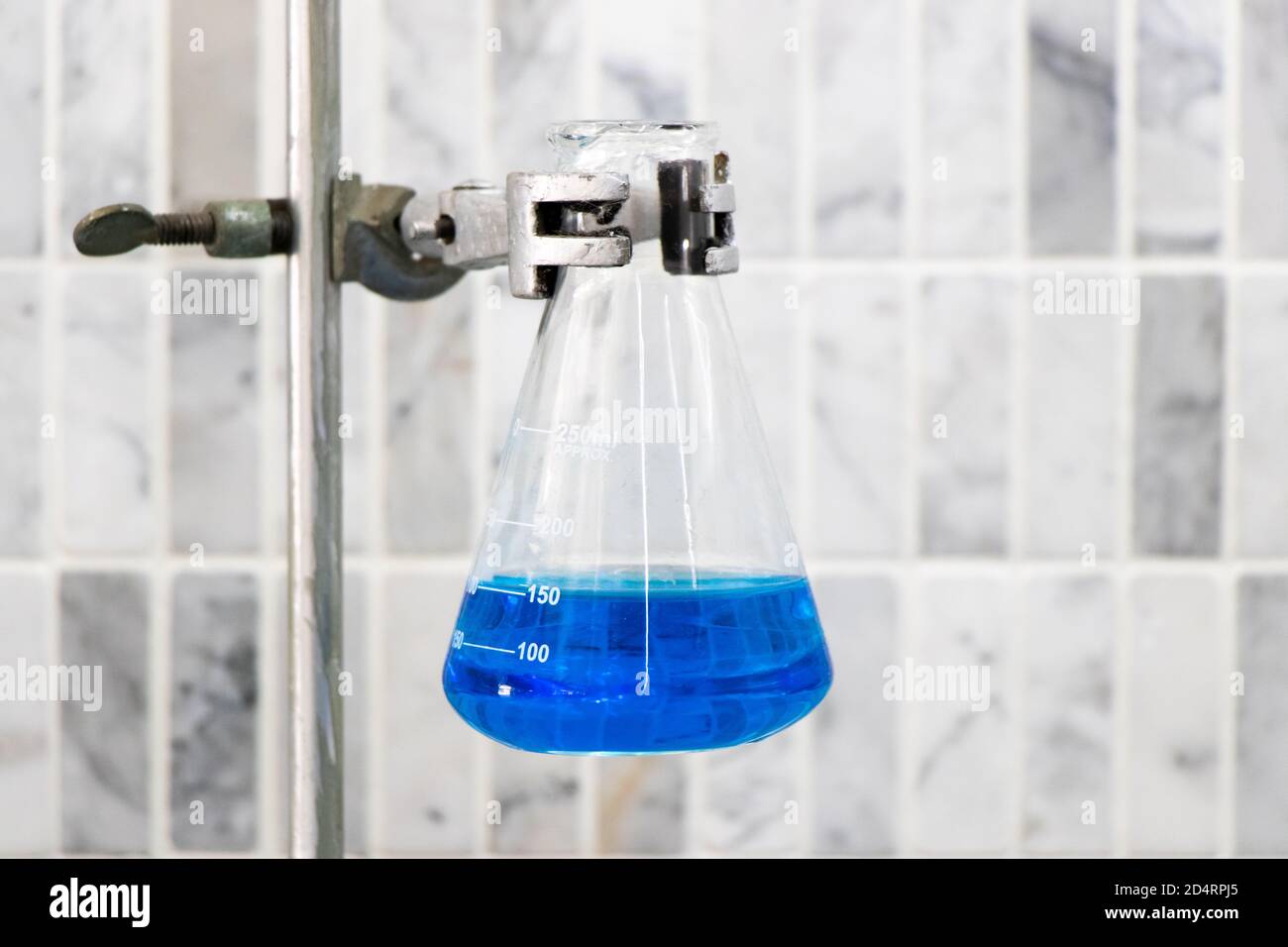 Erlenmeyer flask contain blue color solution on tile background Stock ...