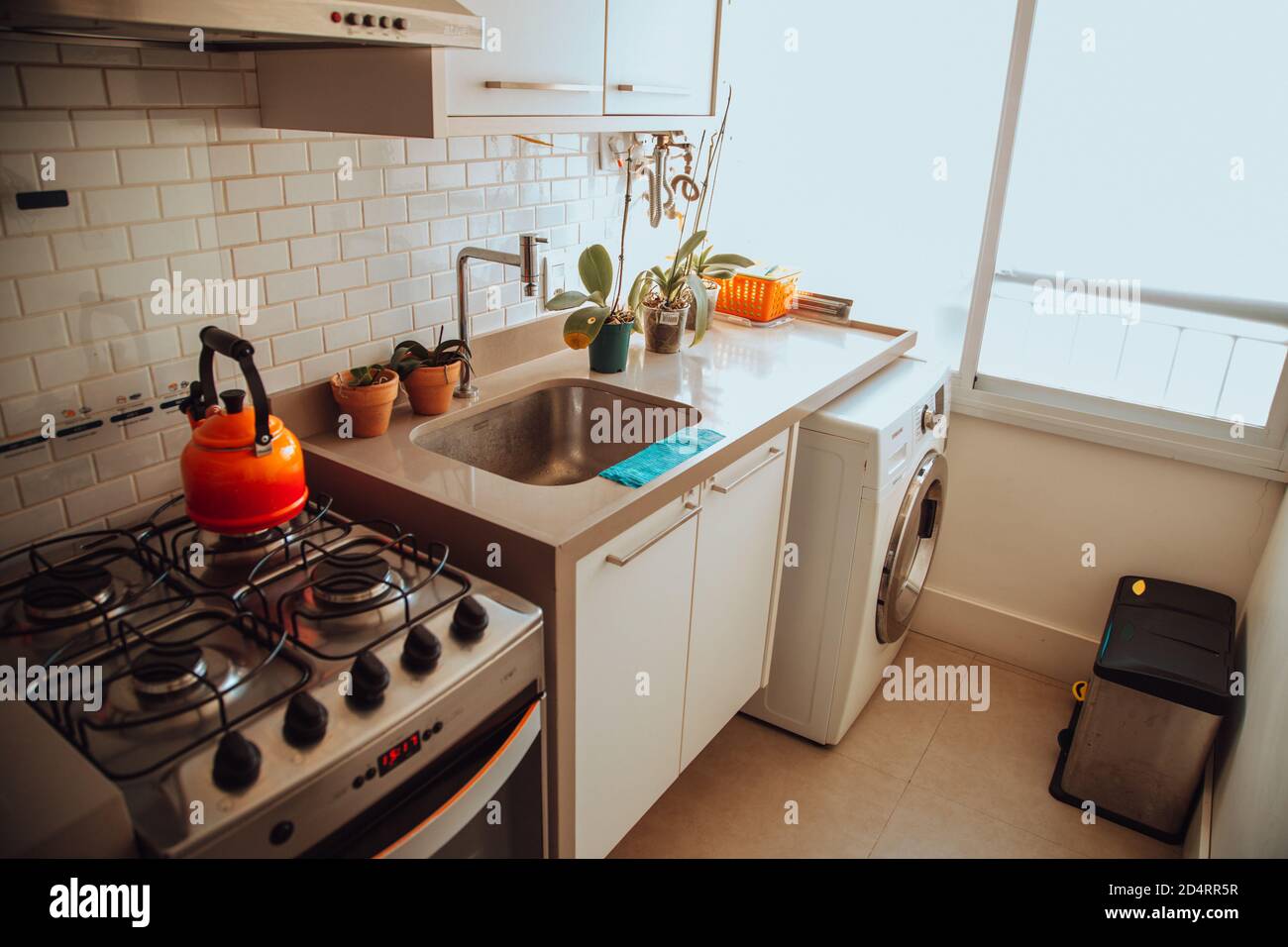 Cozy residential kitchen with windows Stock Photo - Alamy