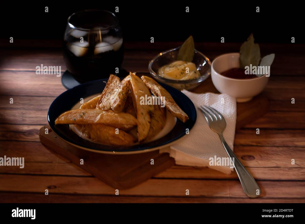 Rustic or country style potato chips with herbs on a small plate with ...