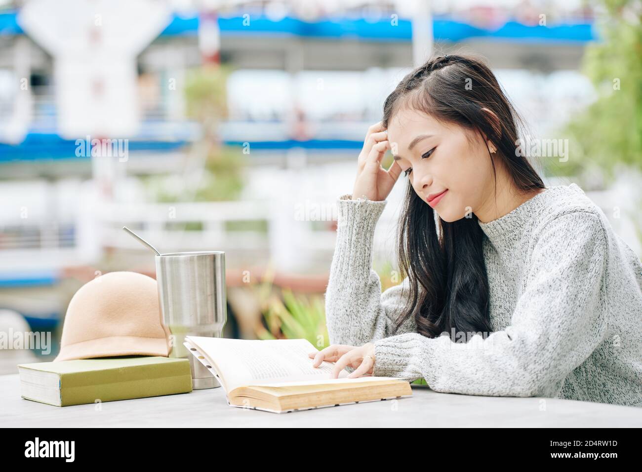 Girl reading interesting book Stock Photo - Alamy