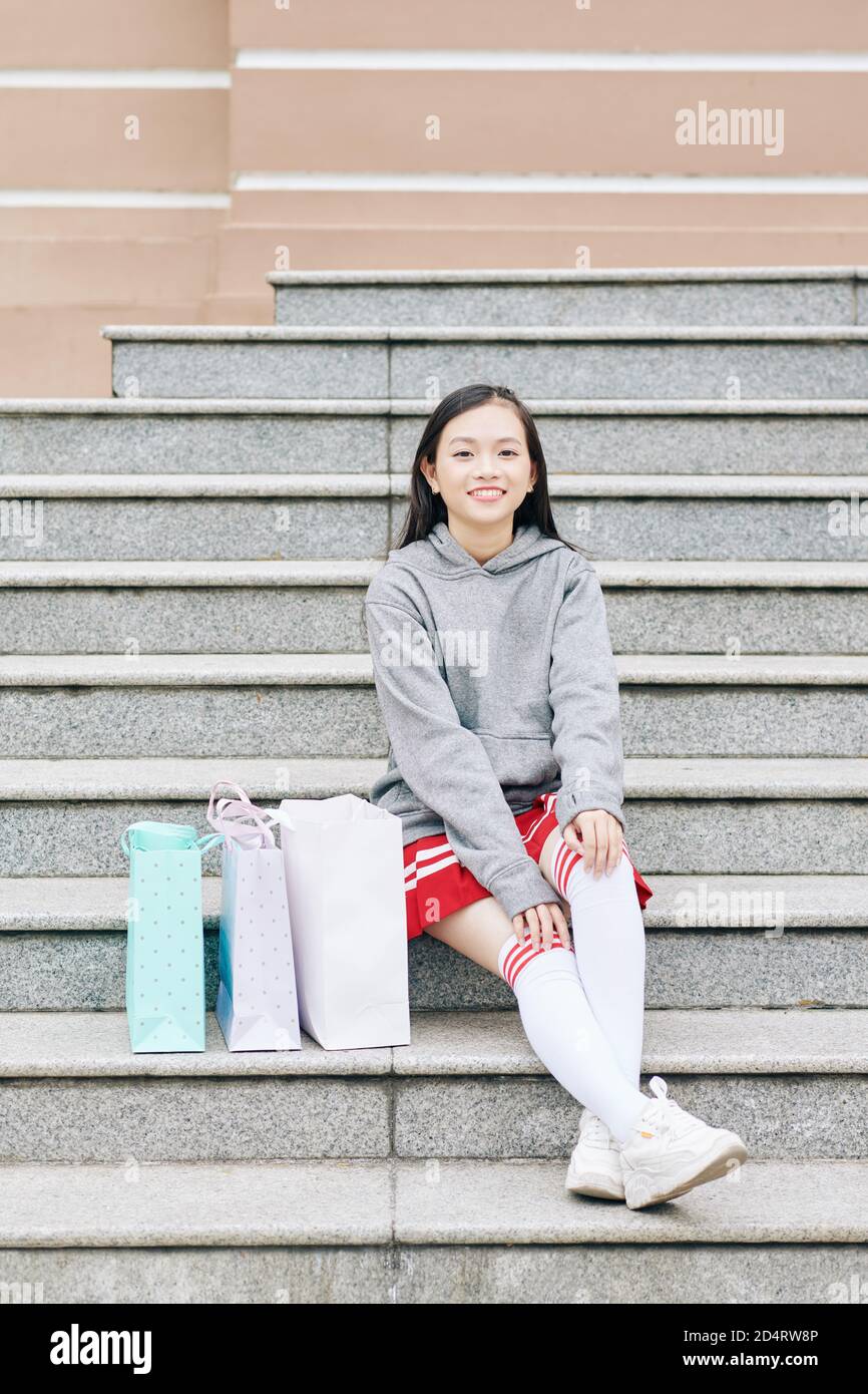 Teenage girl sitting on steps Stock Photo - Alamy