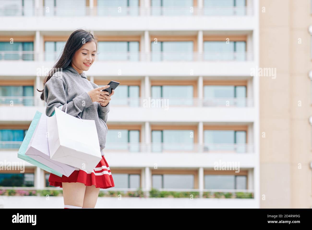 Girl checking social media Stock Photo - Alamy