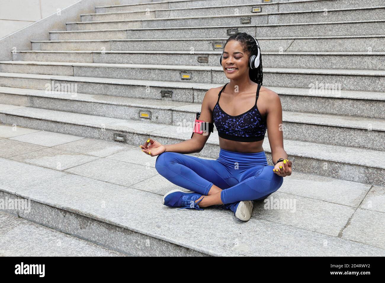 Sportswoman sitting in lotus position Stock Photo - Alamy