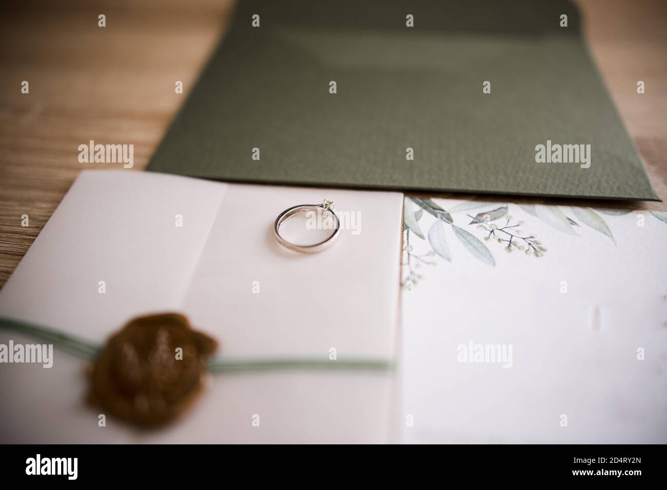 a wedding rings on invitation cards for wedding Stock Photo - Alamy