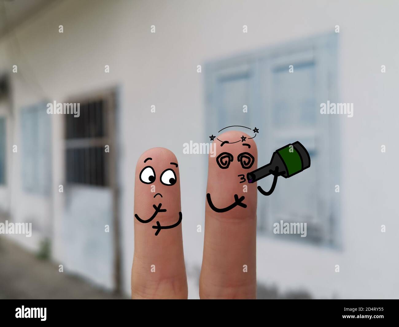 Two fingers are decorated as two person at the street. One of them is ...
