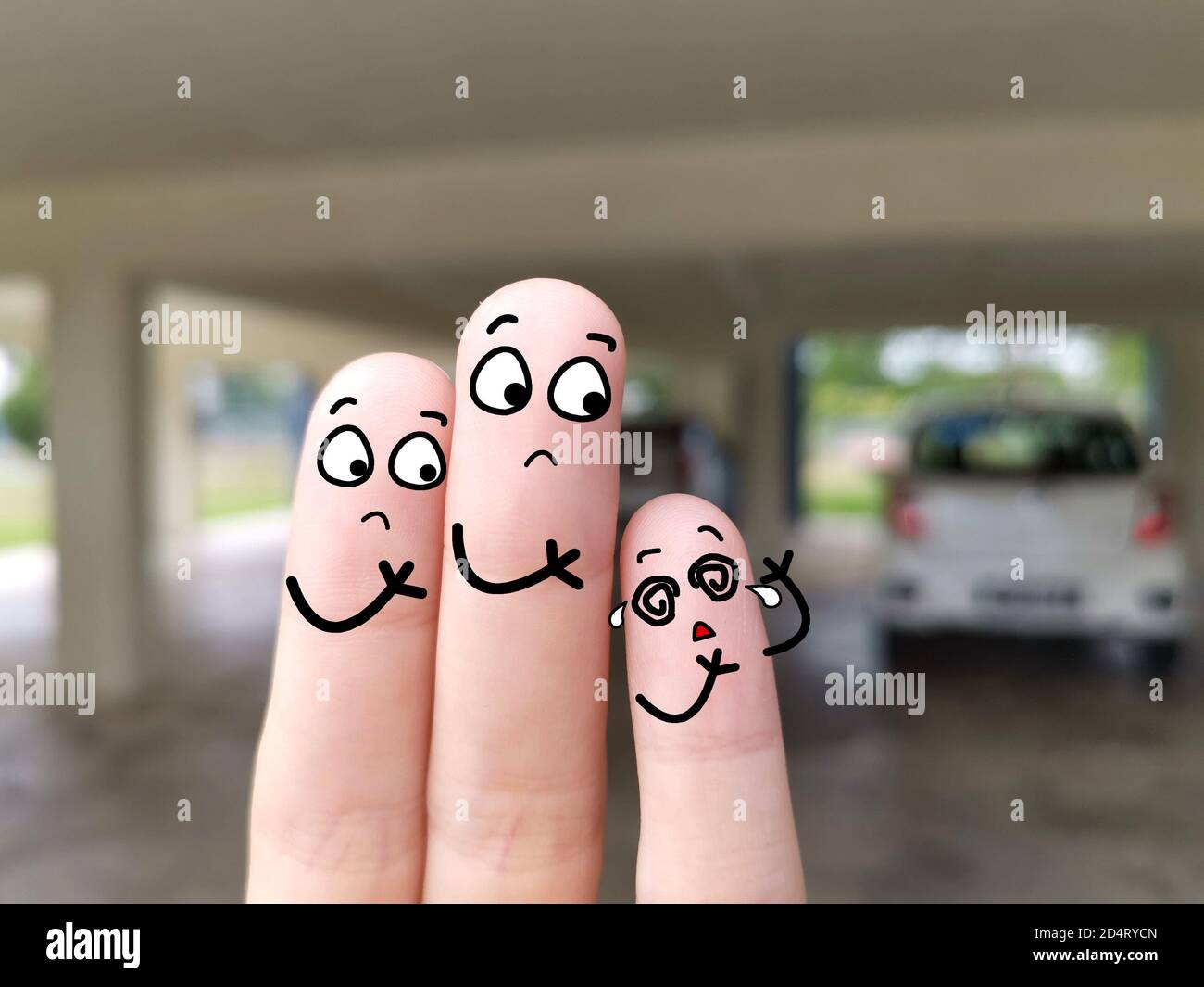 Three fingers are decorated as parents and a child. The child is crying ...