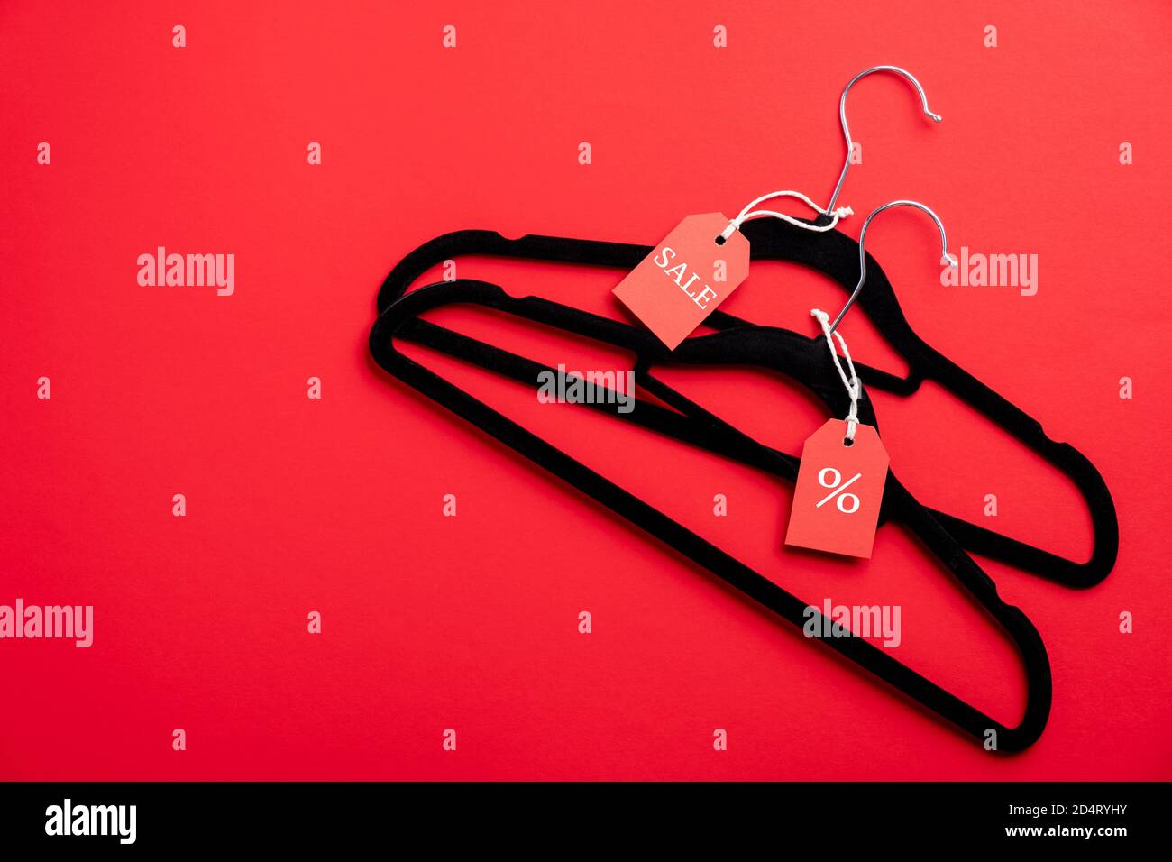 Black Friday sale concept. Two hangers with red labels on red ...