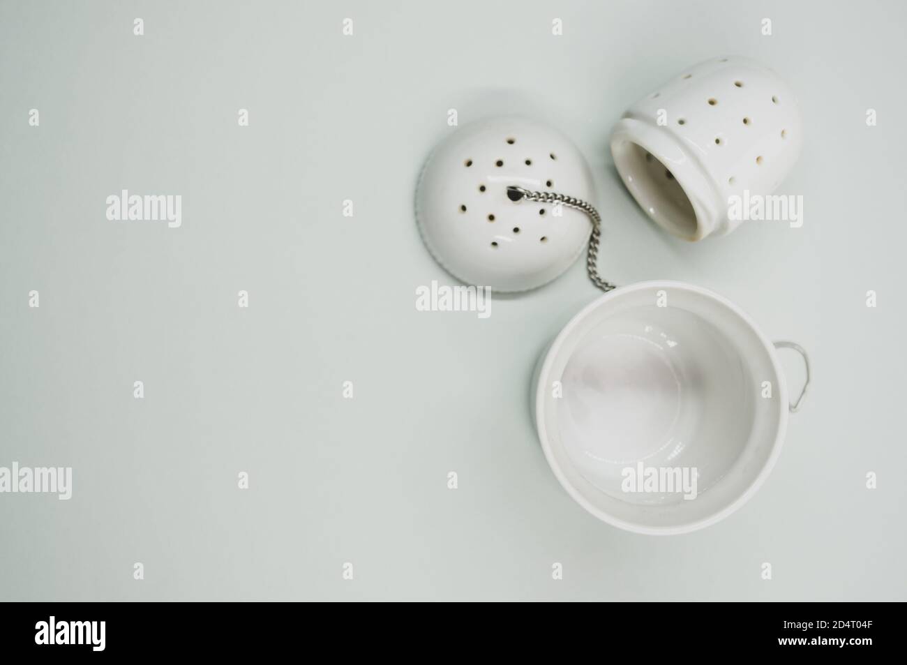 Top view of a white tea strainer with an infuser isolated on a gray ...