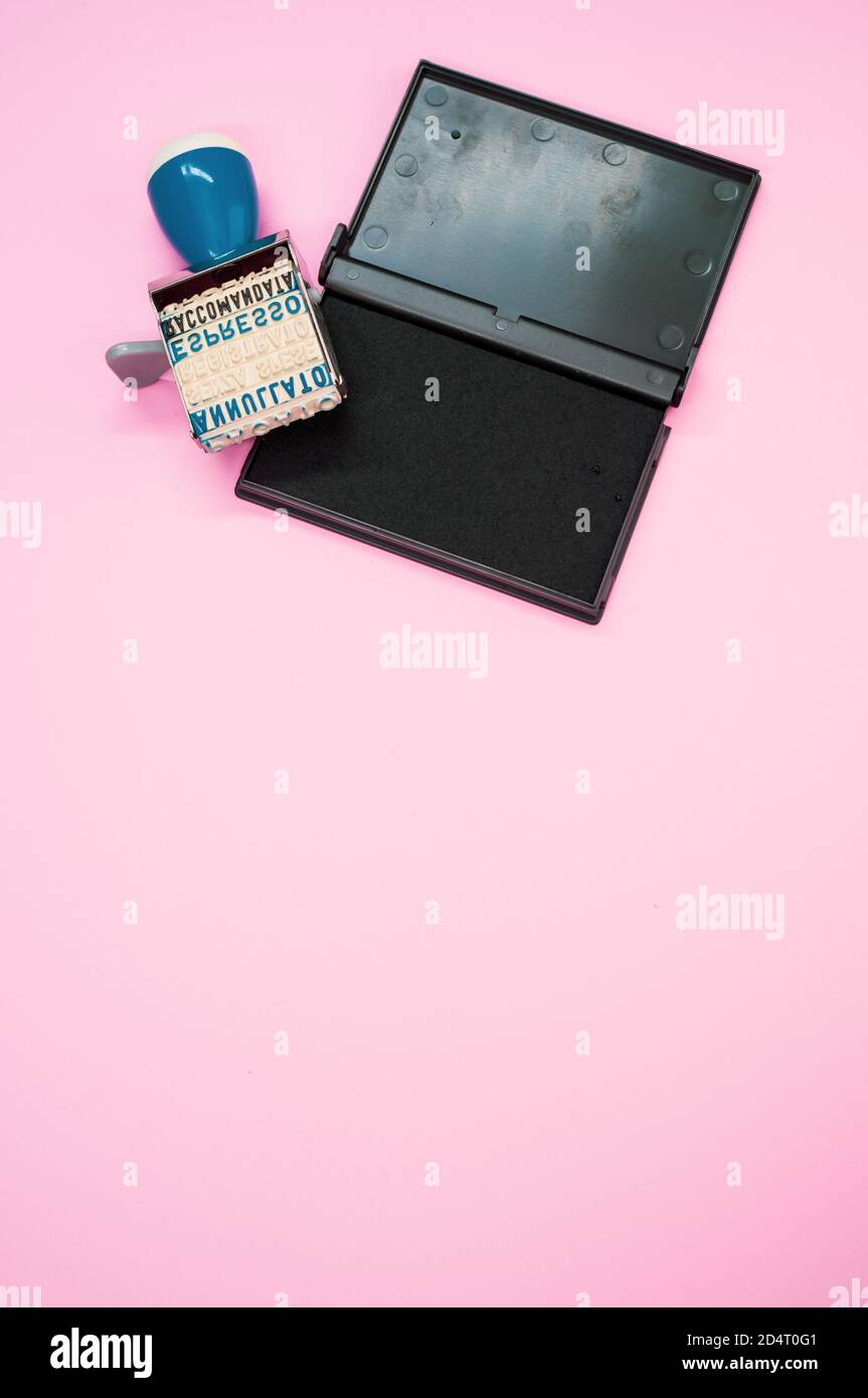 Vertical shot of a rubber stamp roller with words on it with ink ...