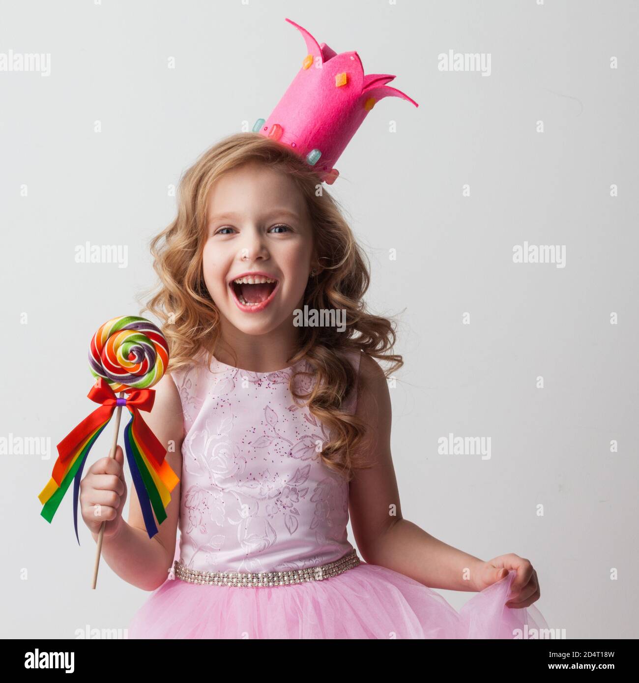 Beautiful excited candy princess girl in crown holding big lollipop and ...