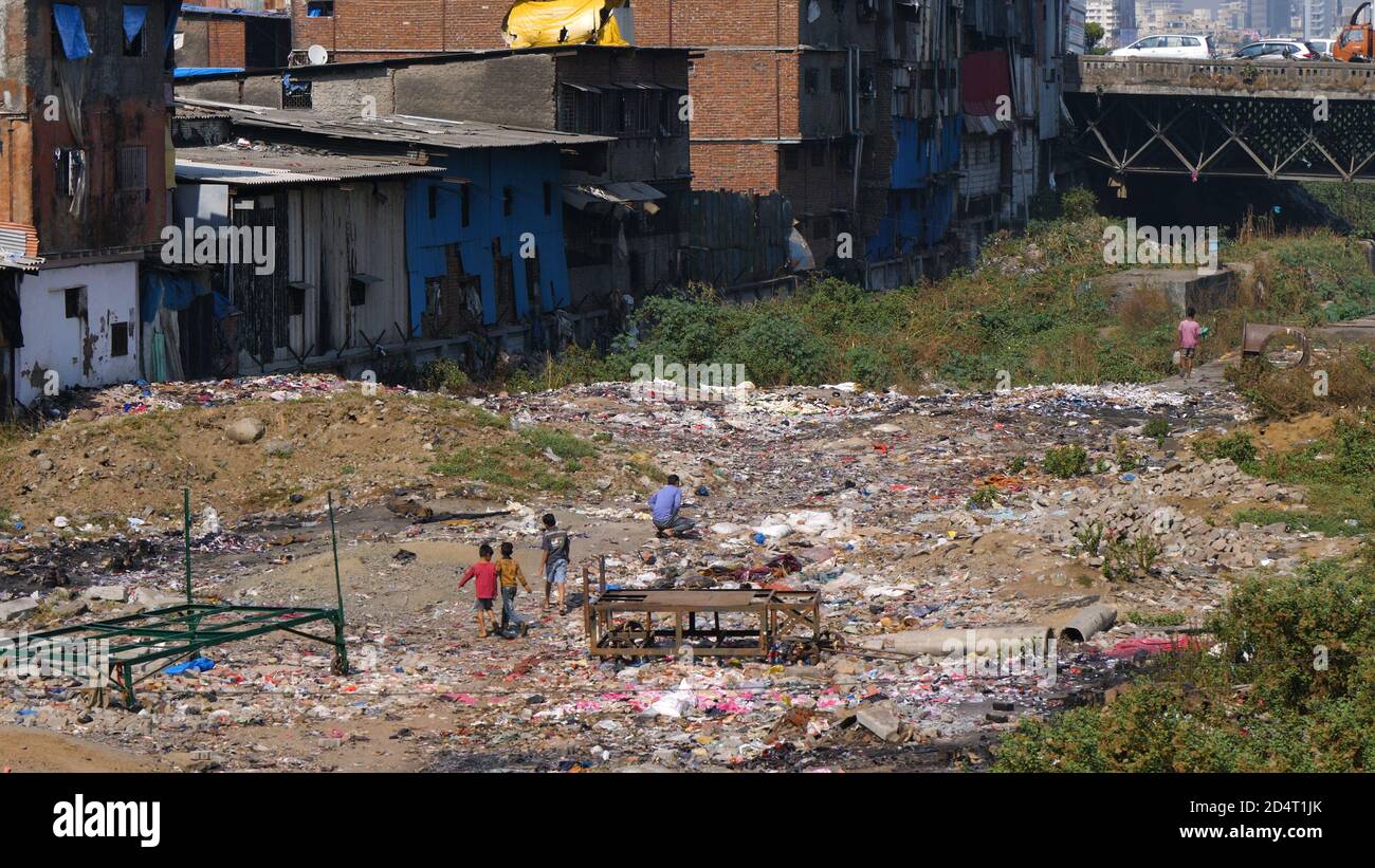 Mumbai, India - December 25, 2017: Children play in piles of trash ...