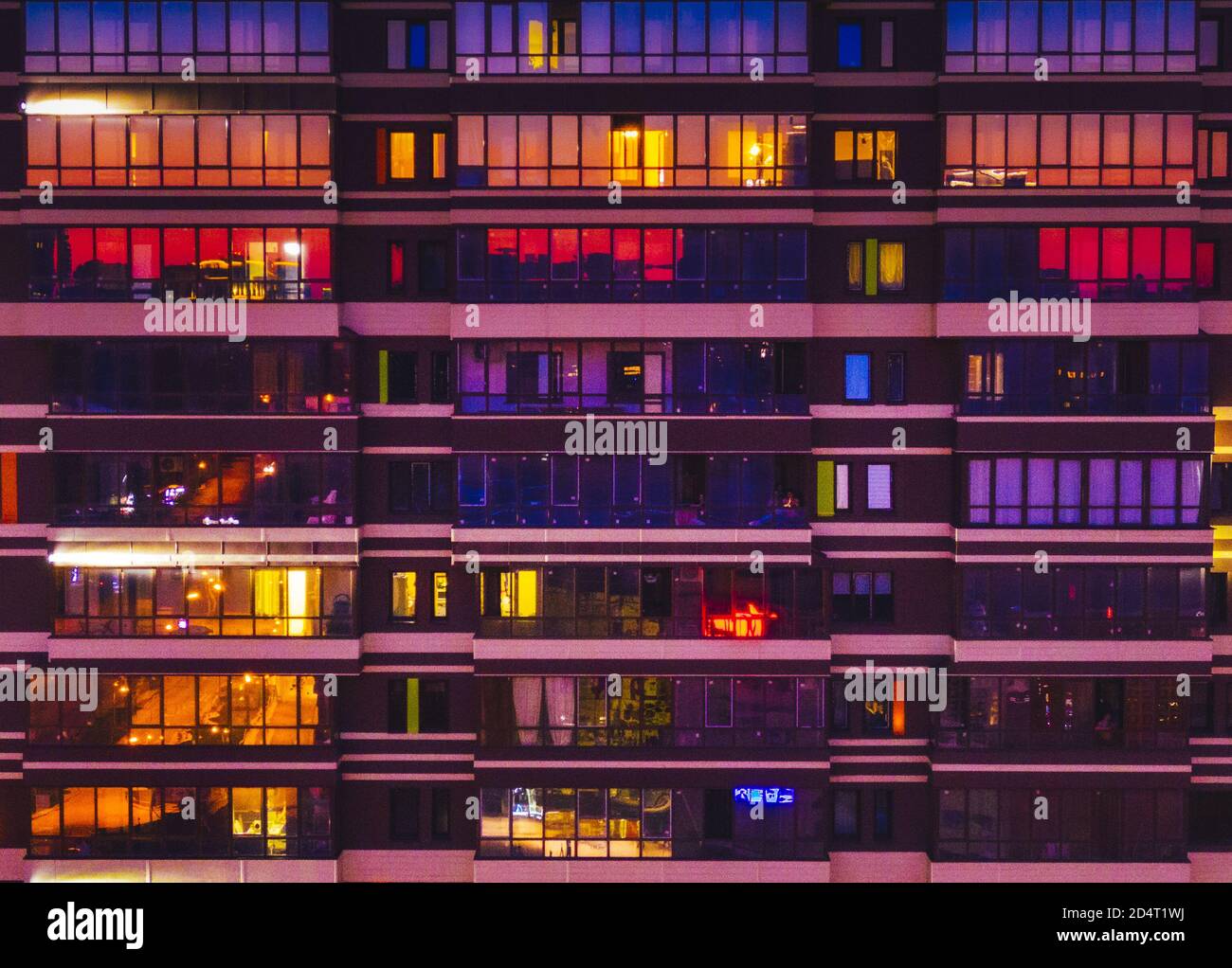 View of building with glass windows and reflection of lights during ...