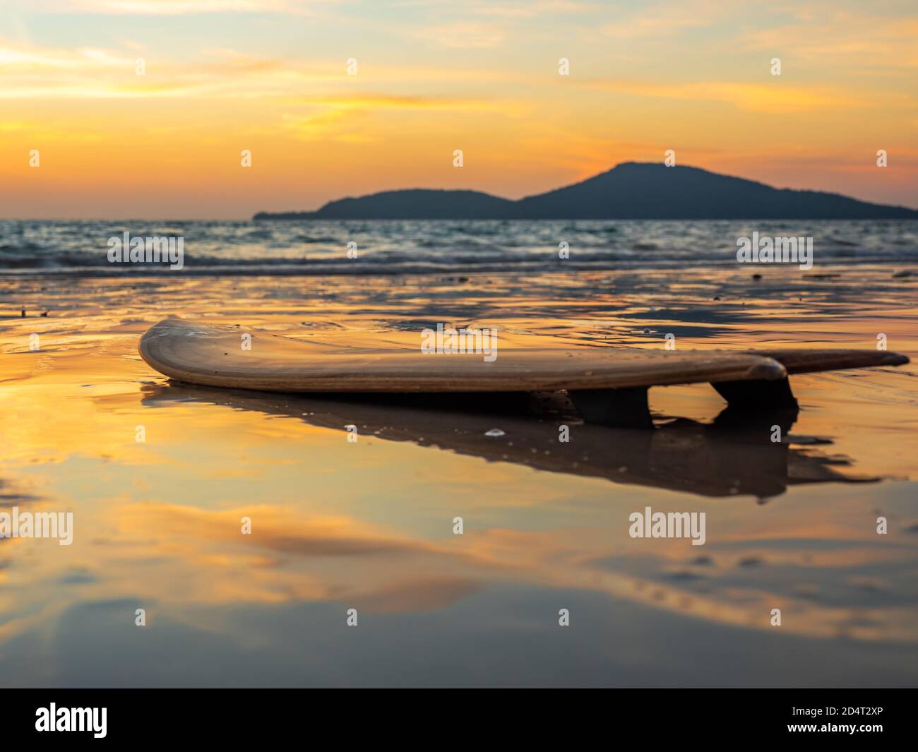 Surfboard on the beach at sunset Stock Photo - Alamy
