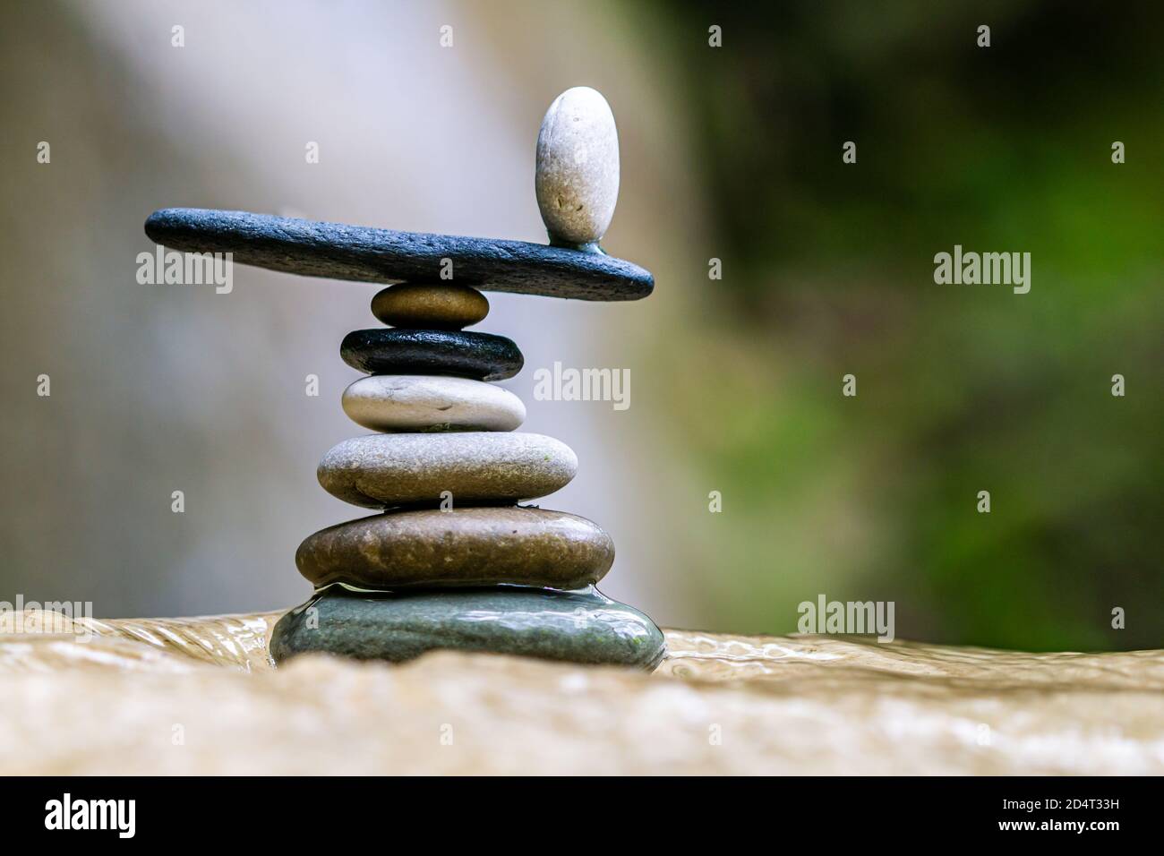 Balanced Zen stones pebbles at the waterfalls Stock Photo - Alamy