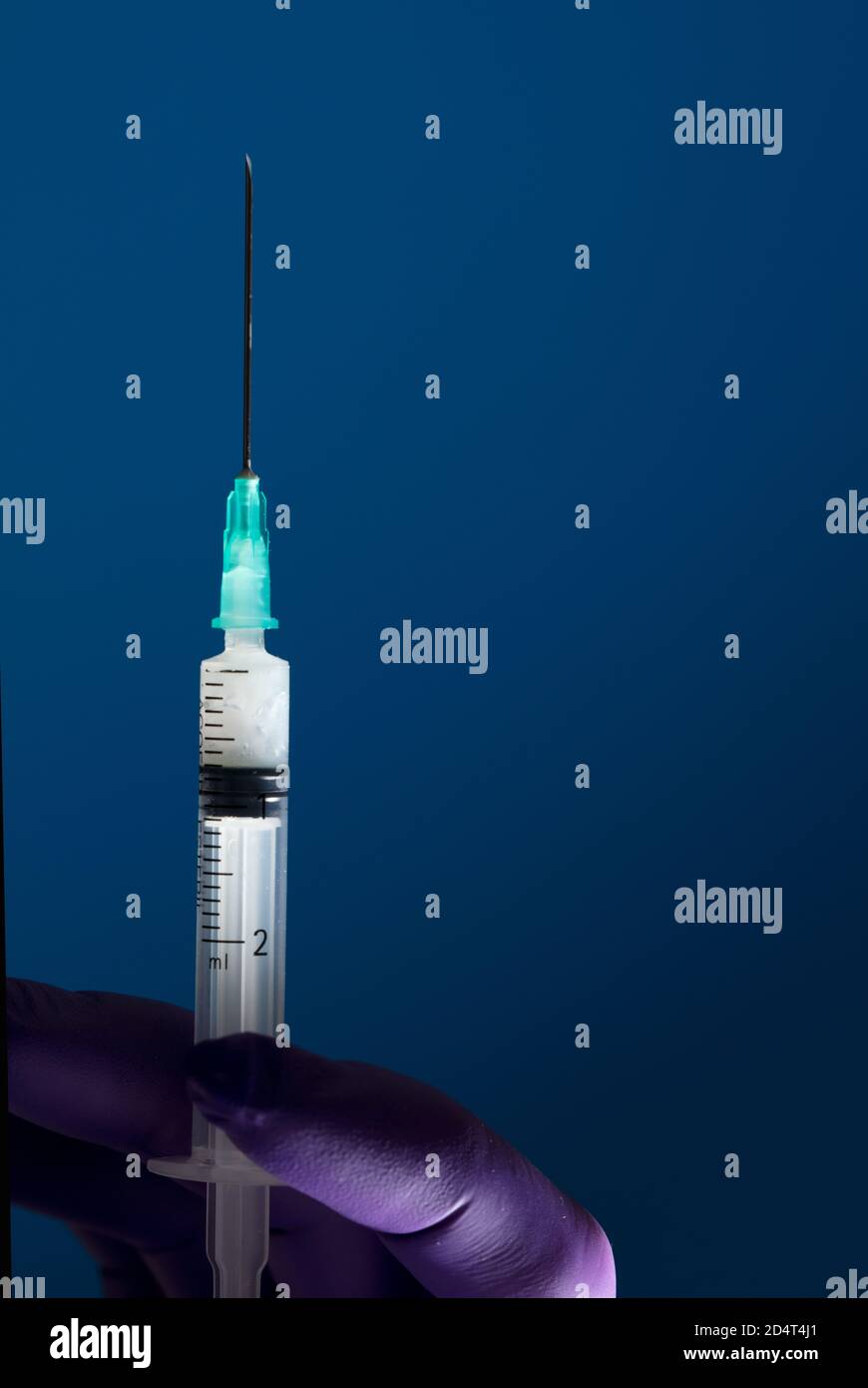Syringe cannula with blue background, close-up Stock Photo - Alamy