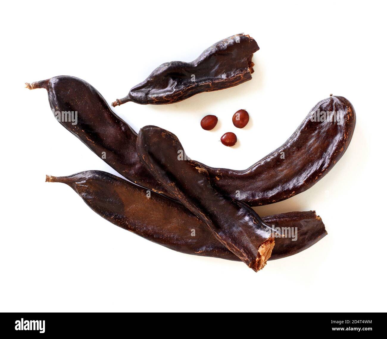 Dry carob pods and seeds top view isolated on white Stock Photo - Alamy
