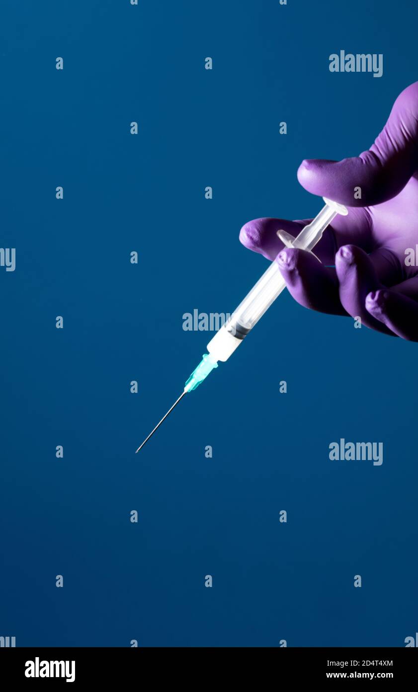 Syringe, medical injection in the hand, palm or fingers. Plastic ...