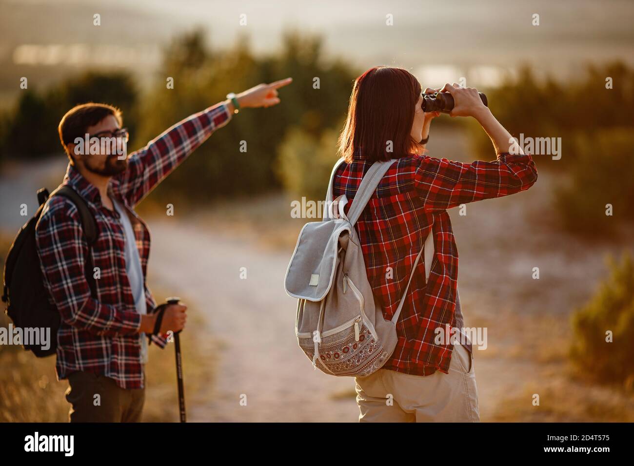 Portrait of happy young couple having fun on their hiking trip ...