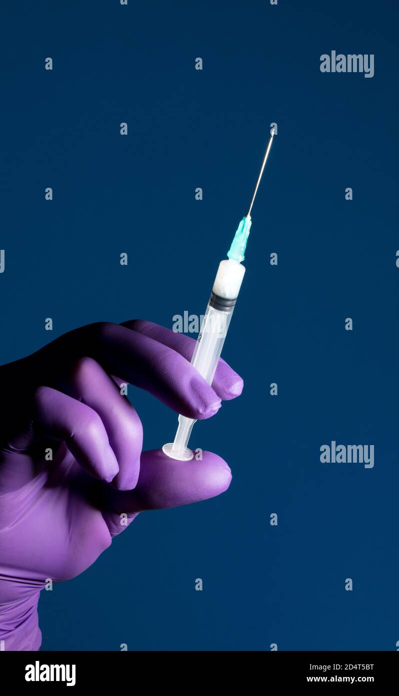 Syringe, medical injection in the hand, palm or fingers. Plastic ...