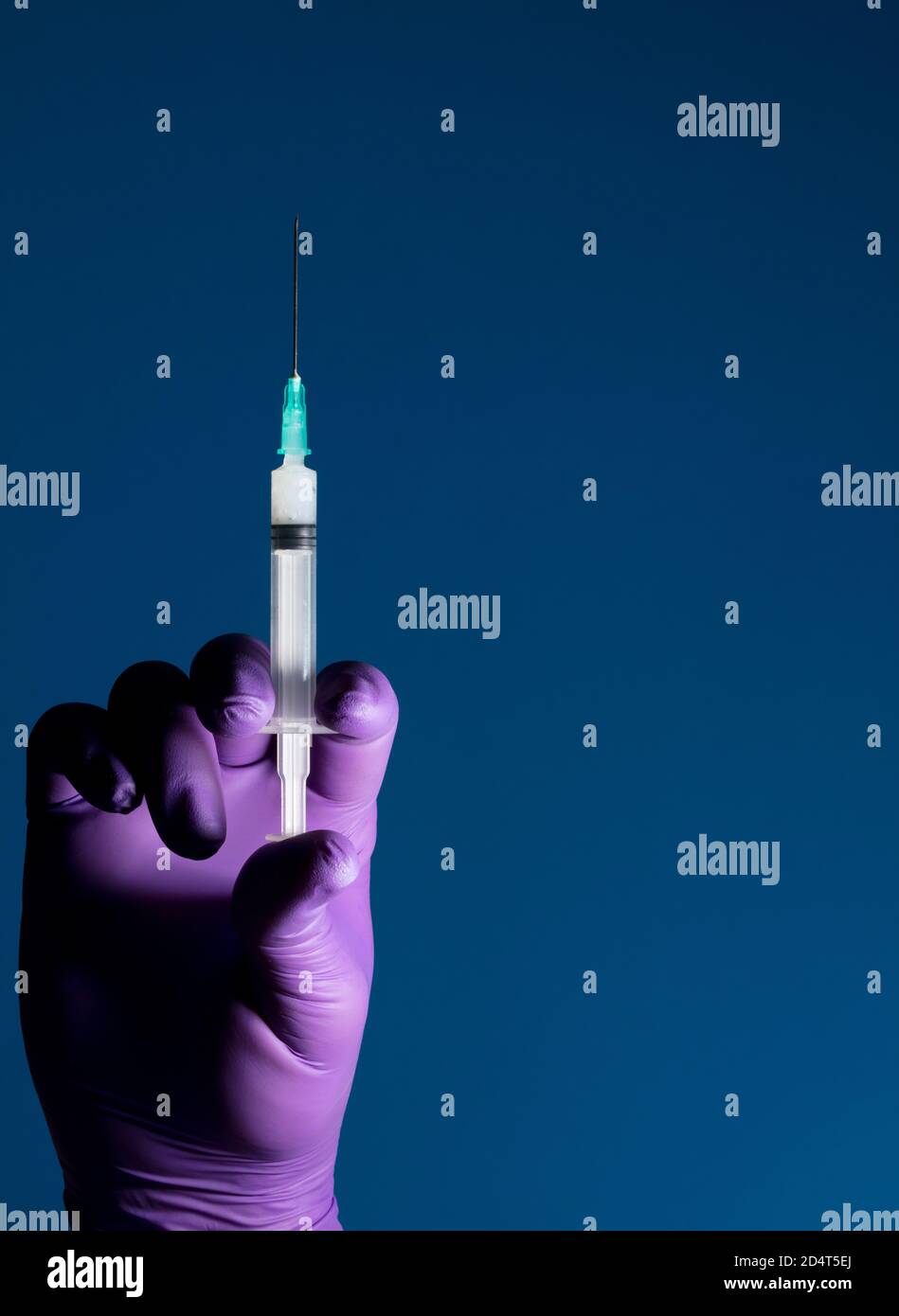 Syringe, medical injection in the hand, palm or fingers. Plastic ...