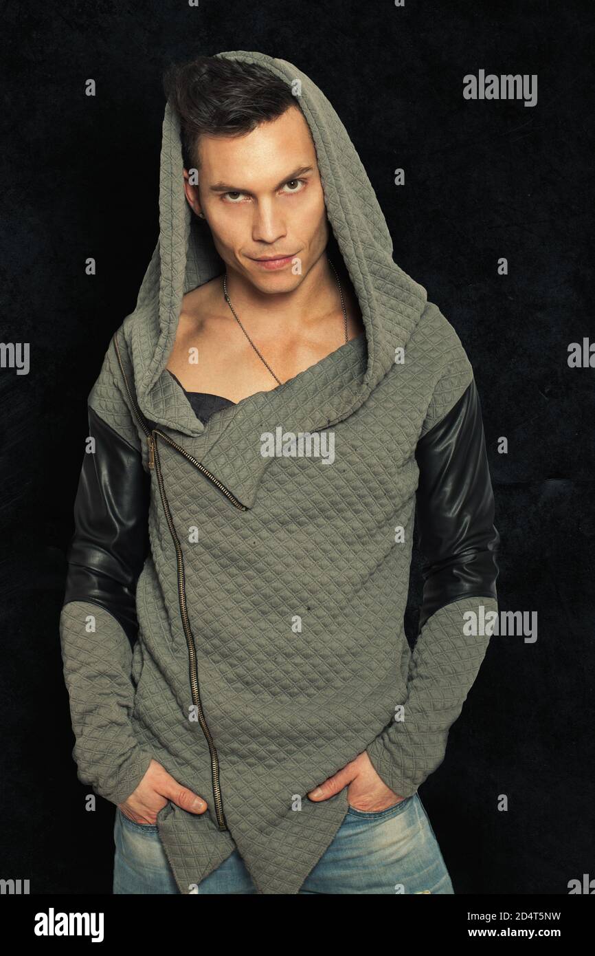 Mysterious man with hood. Portrait fashionable man. Black grunge ...