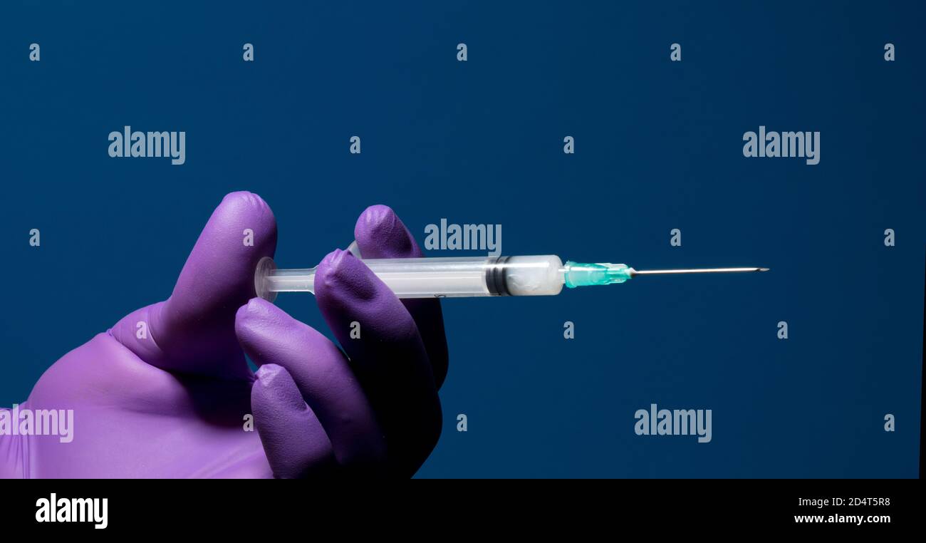 Syringe, medical injection in the hand, palm or fingers. Plastic ...