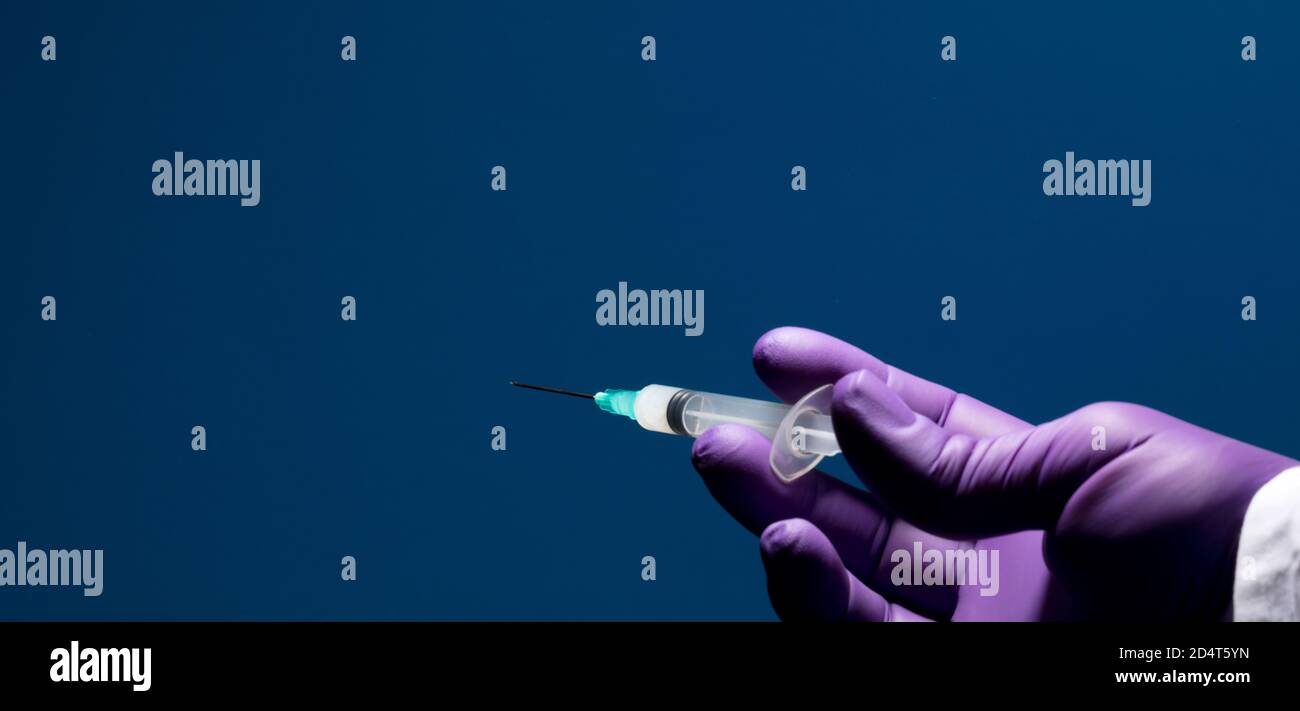 Syringe, medical injection in the hand, palm or fingers. Plastic ...