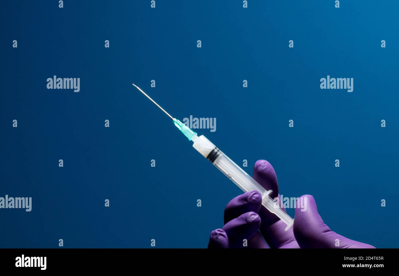 Syringe, medical injection in the hand, palm or fingers. Plastic ...