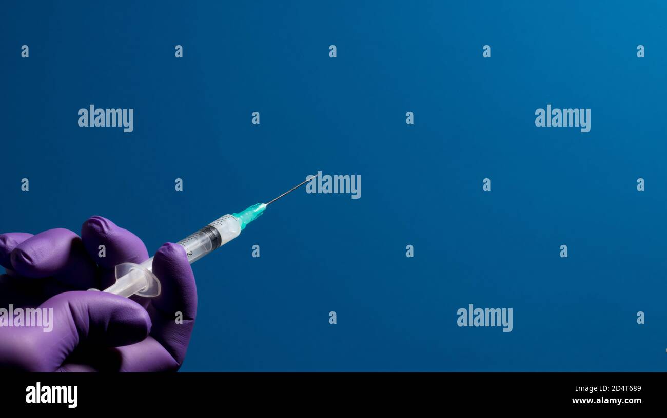 Syringe, medical injection in the hand, palm or fingers. Plastic ...