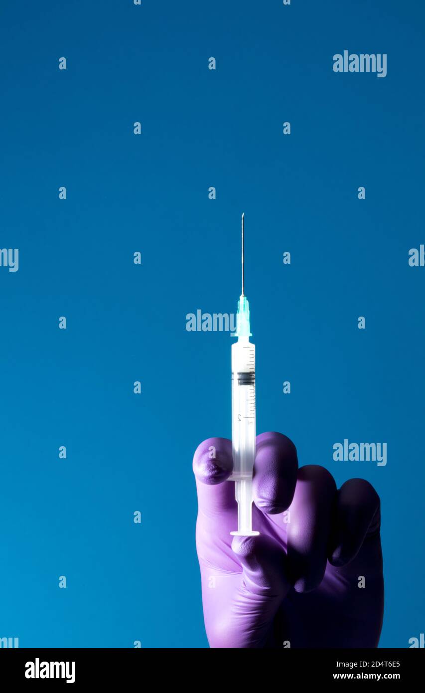 Syringe, medical injection in the hand, palm or fingers. Plastic ...