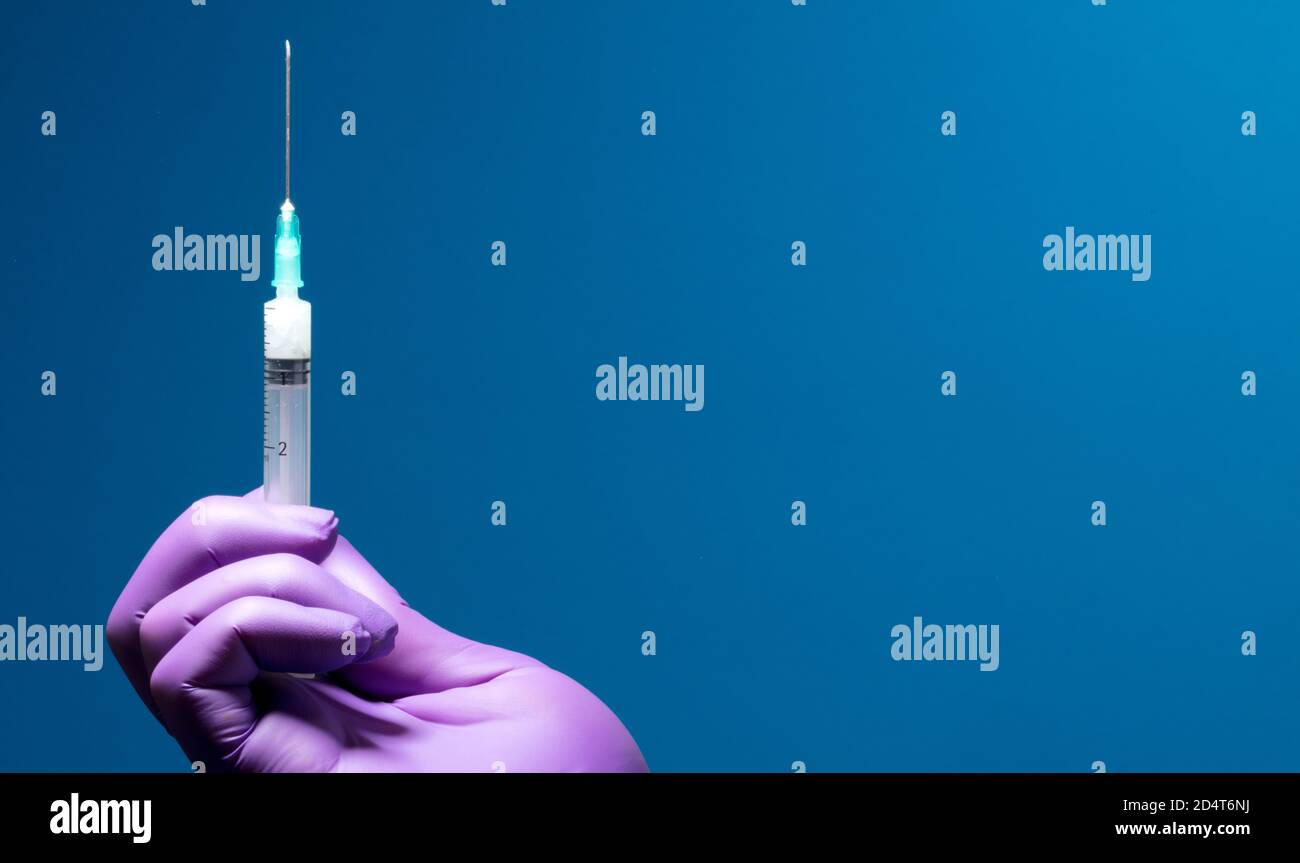 Syringe, medical injection in the hand, palm or fingers. Plastic ...