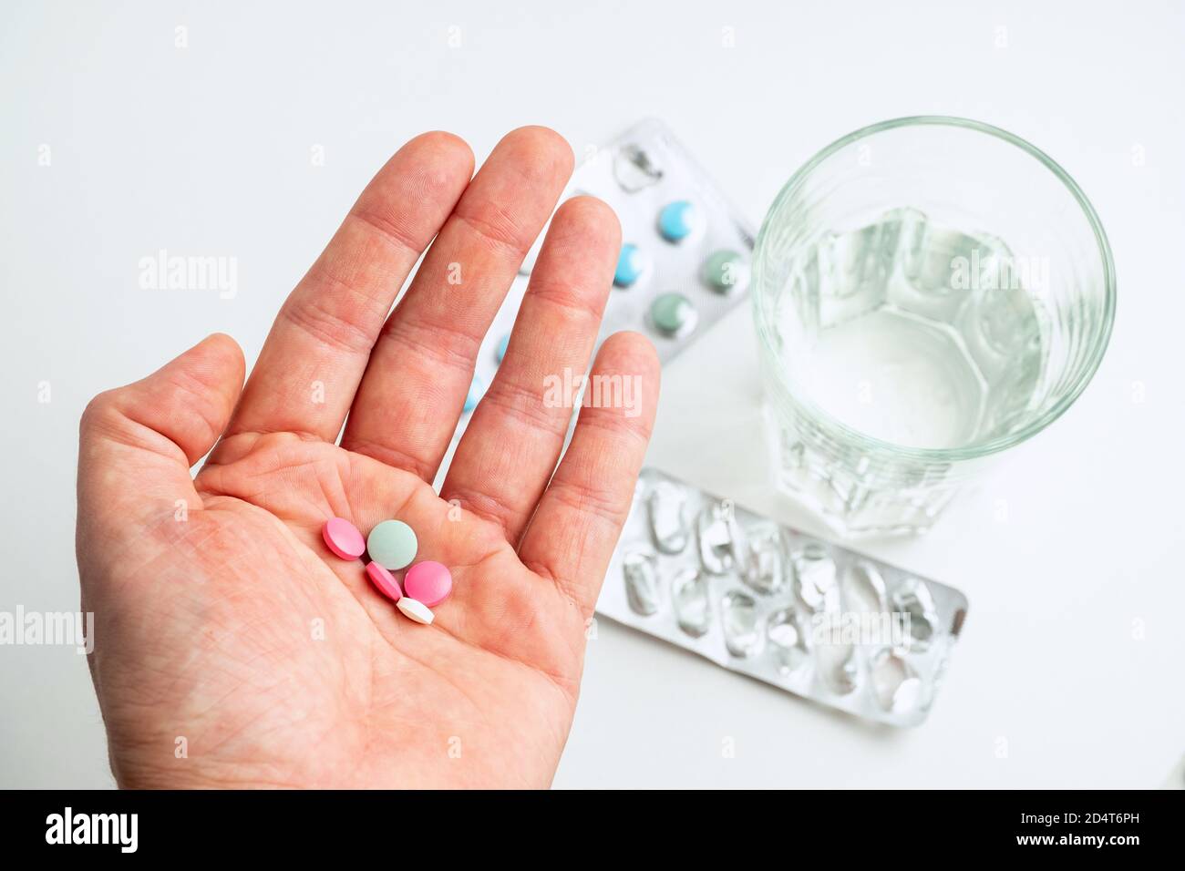 Concept of taking medication with hand and pills with a glass of water ...