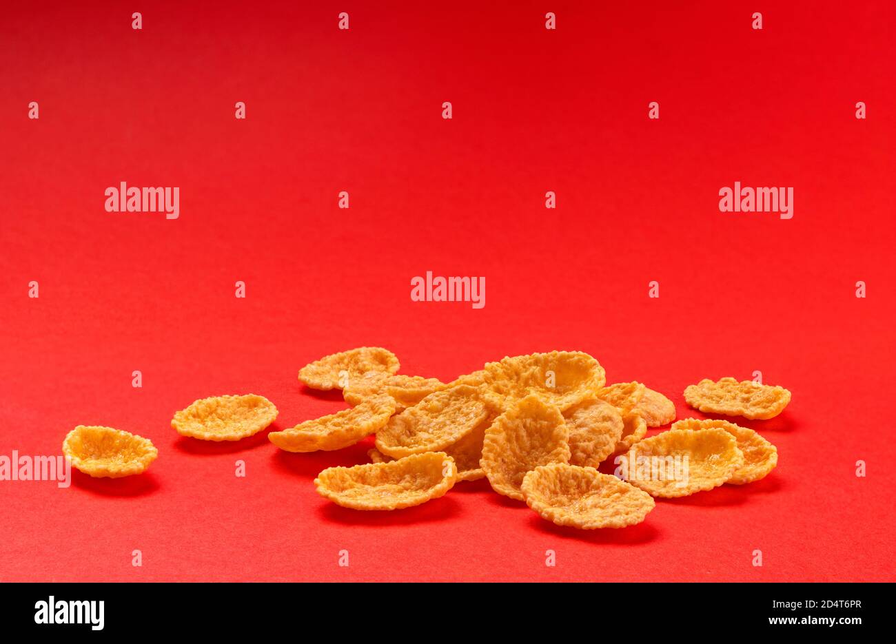 Corn flakes isolated on red color background, full depth of field Stock ...