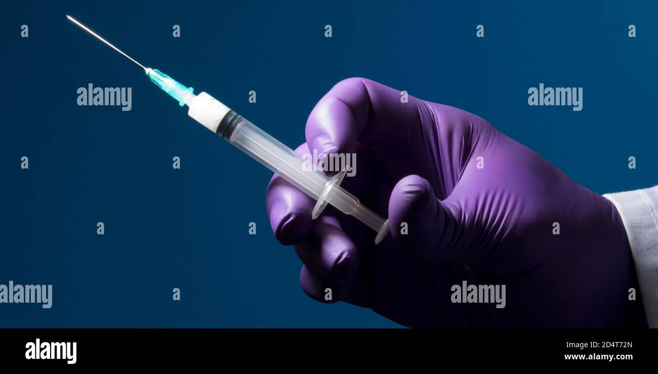 Syringe, medical injection in the hand, palm or fingers. Plastic ...