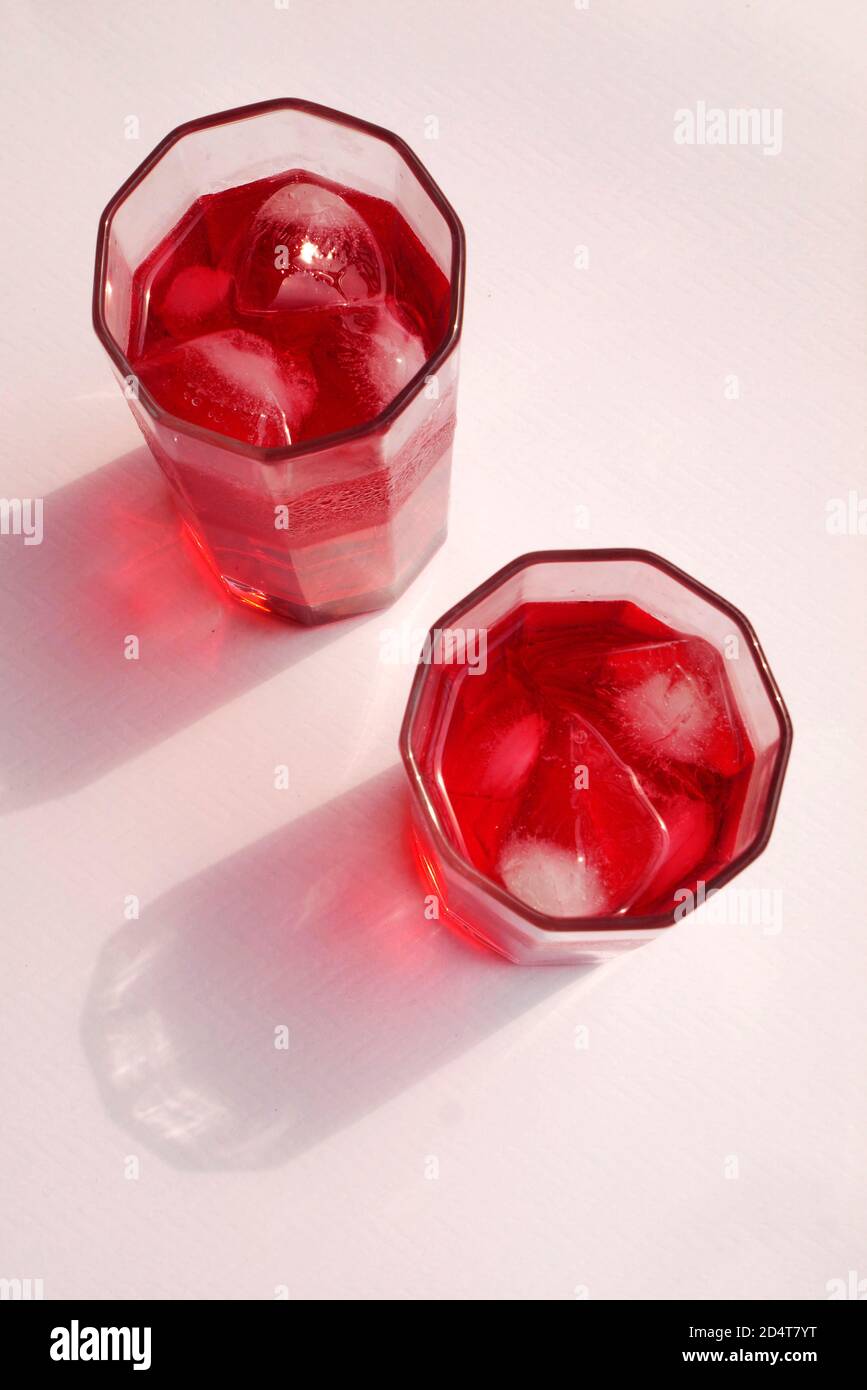 RED SHERBET WITH ICE IN A GLASS WITH A STRONG SHADOW Stock Photo - Alamy