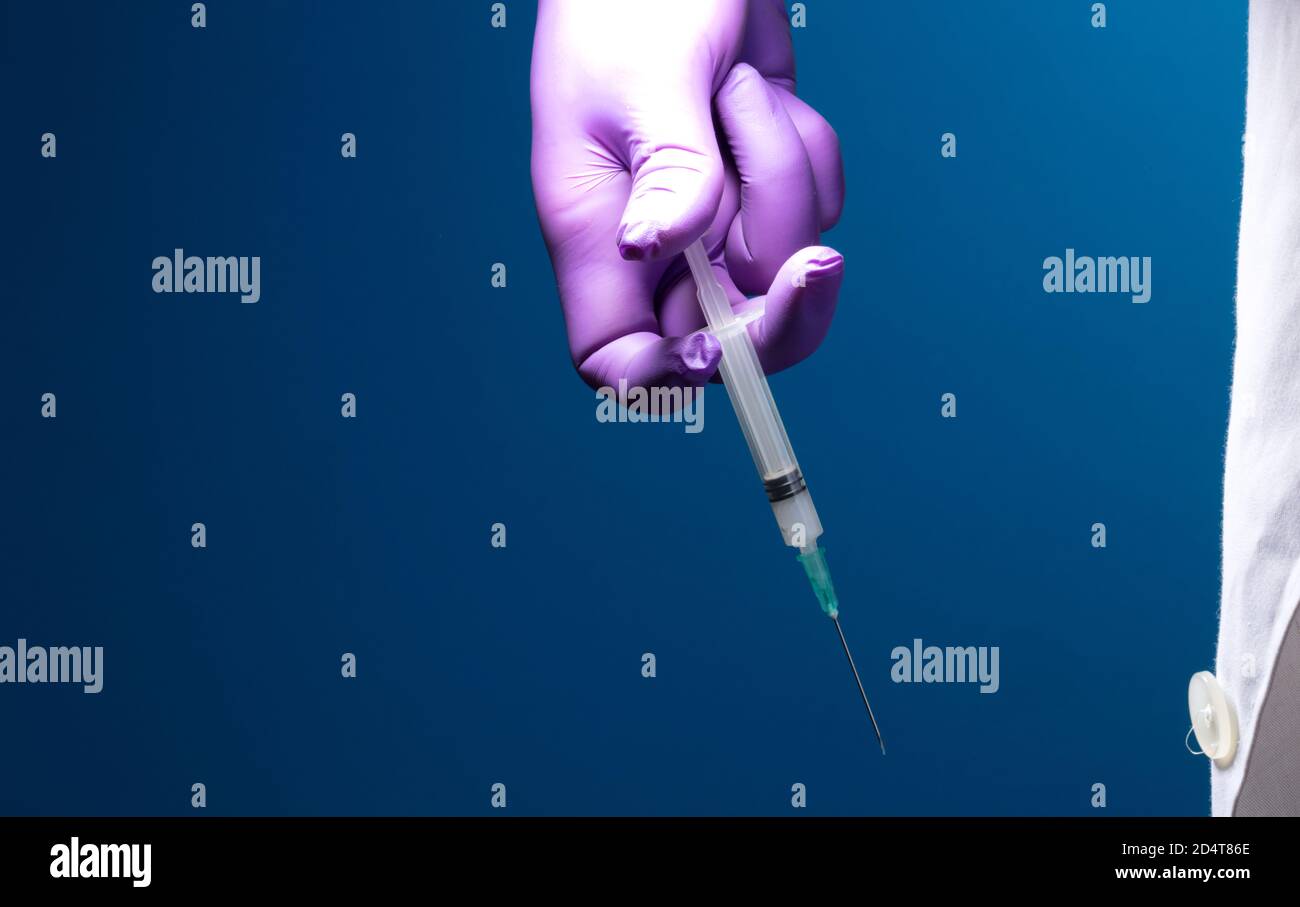 Syringe, medical injection in the hand, palm or fingers. Plastic ...