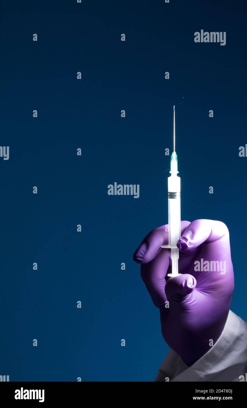 Syringe, medical injection in the hand, palm or fingers. Plastic ...