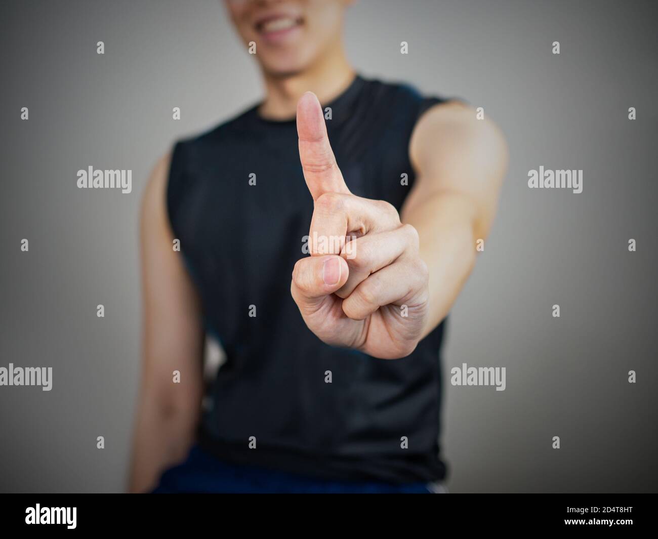 One hand gesture, single index finger by man waring sport wear Stock ...