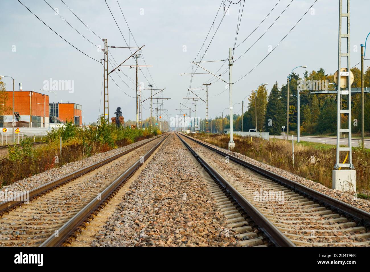 Two lane railroad with electric power lines Stock Photo - Alamy