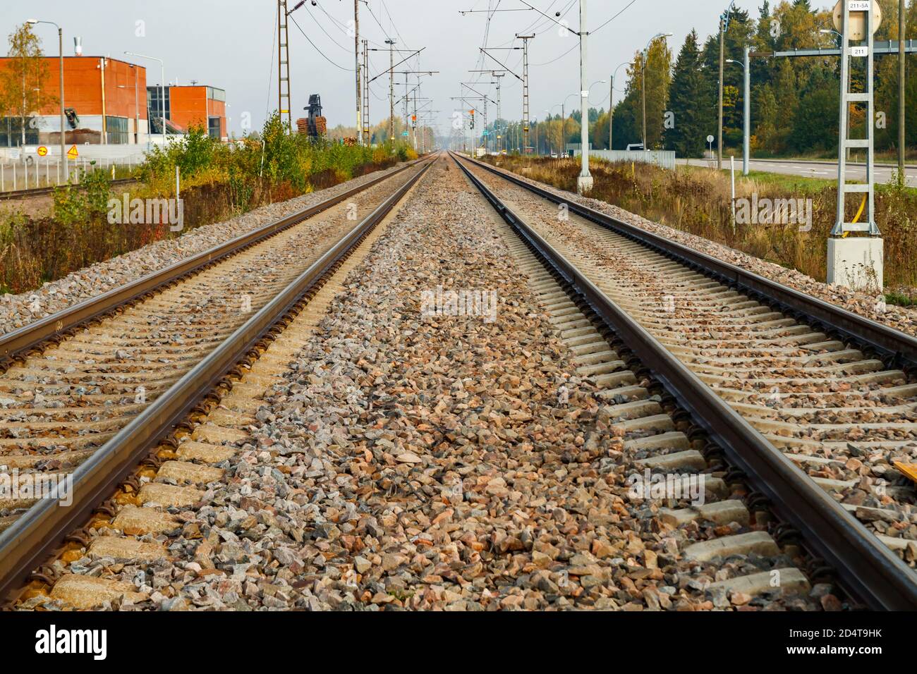 Two lane railroad with electric power lines Stock Photo - Alamy