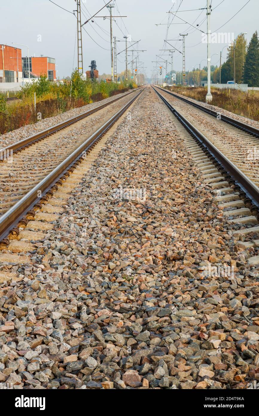 Two lane railroad with electric power lines Stock Photo - Alamy