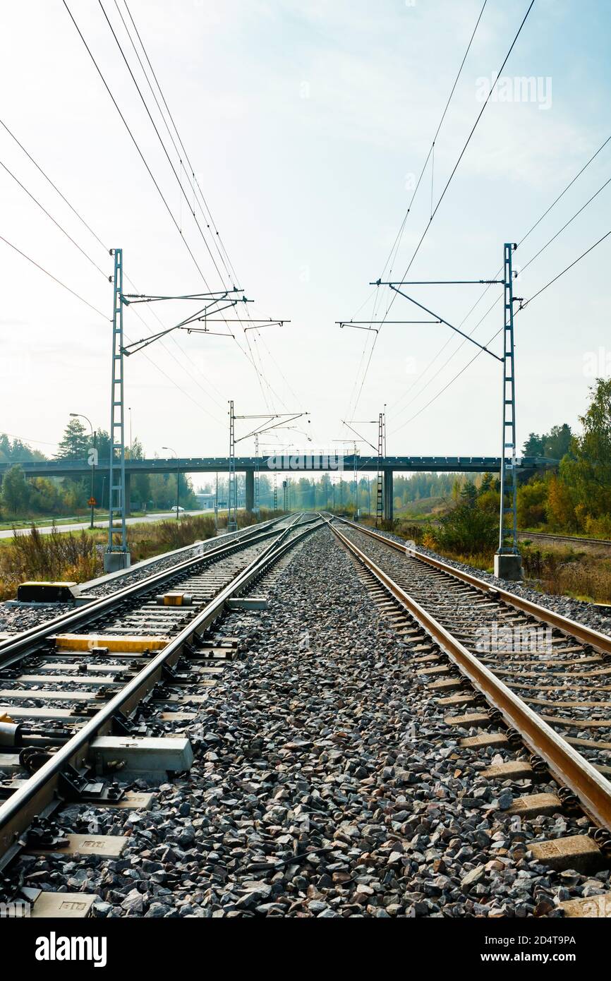 Two lane railroad with electric power lines Stock Photo - Alamy