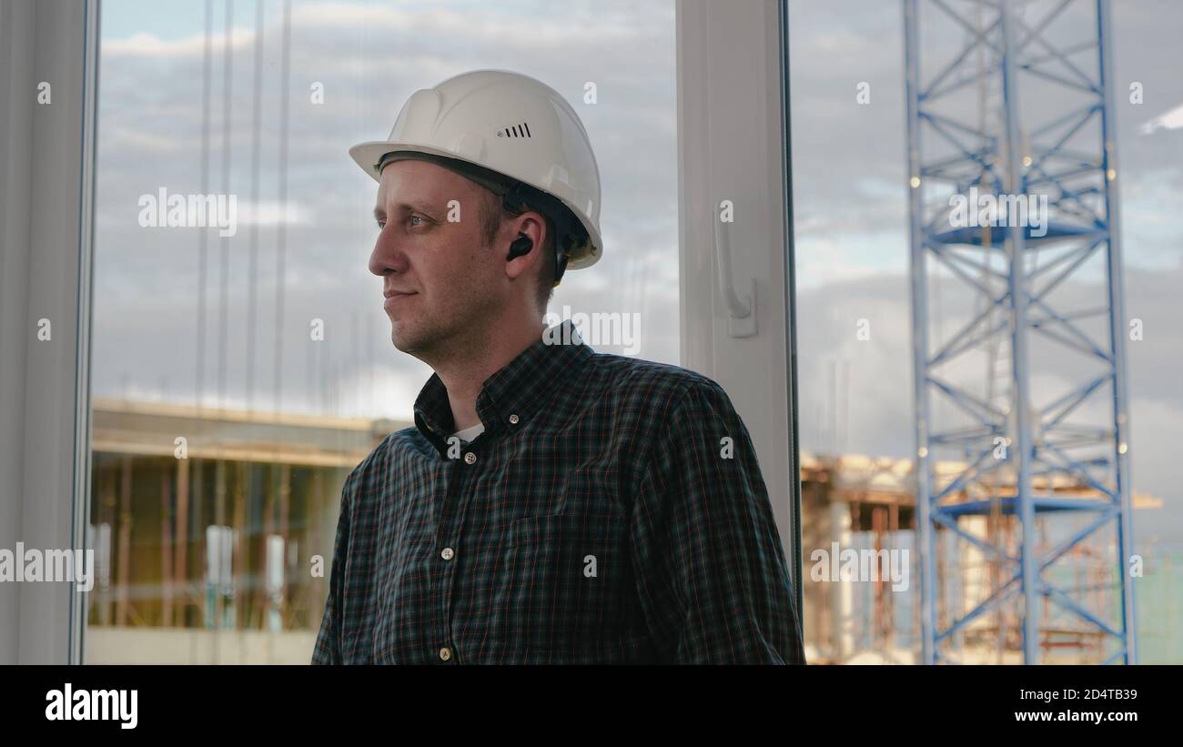 Engineer having a relax time listening to music in wireless headphones ...