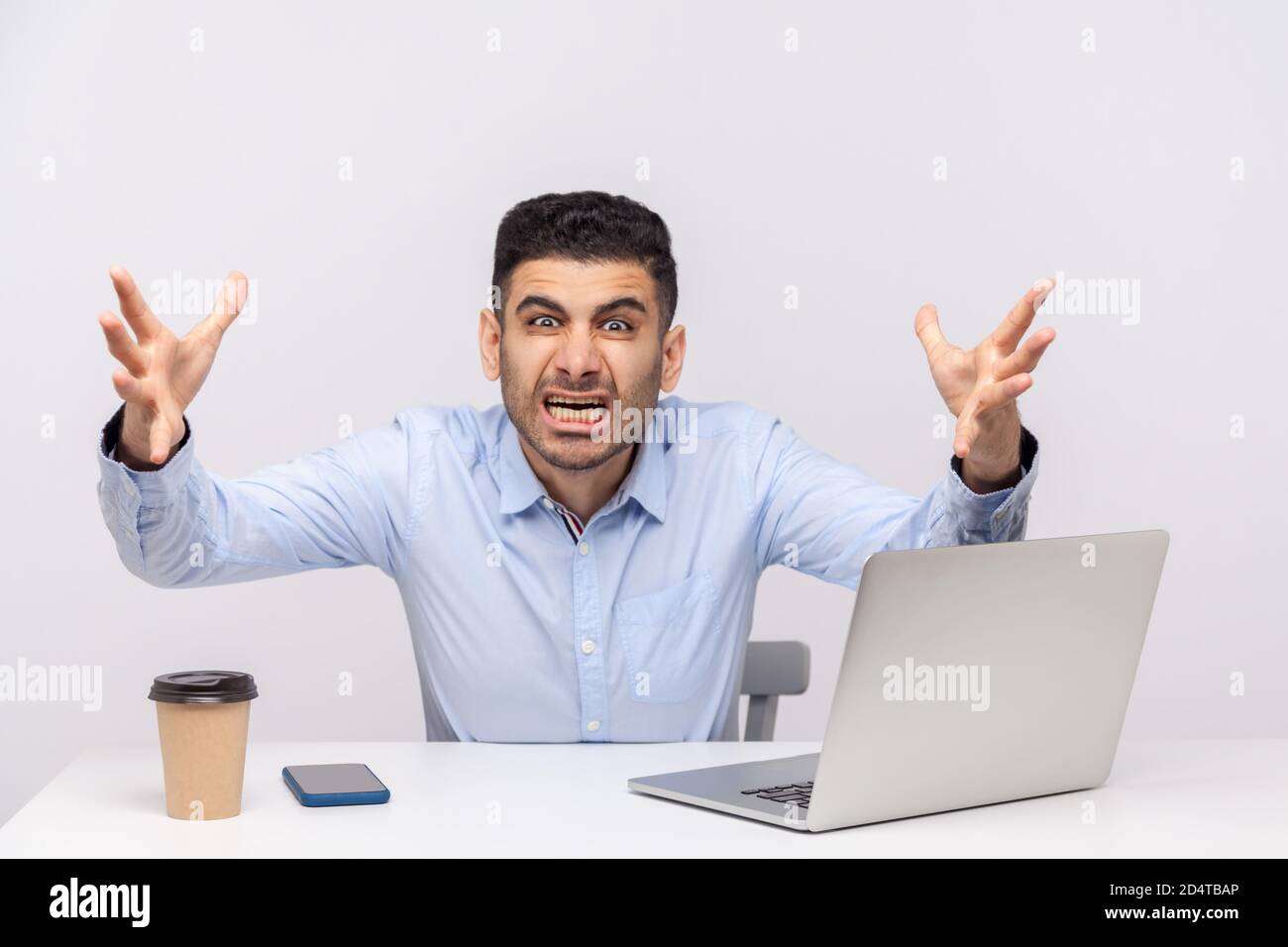 Irritated man boss sitting office workplace, stretching hands to camera ...