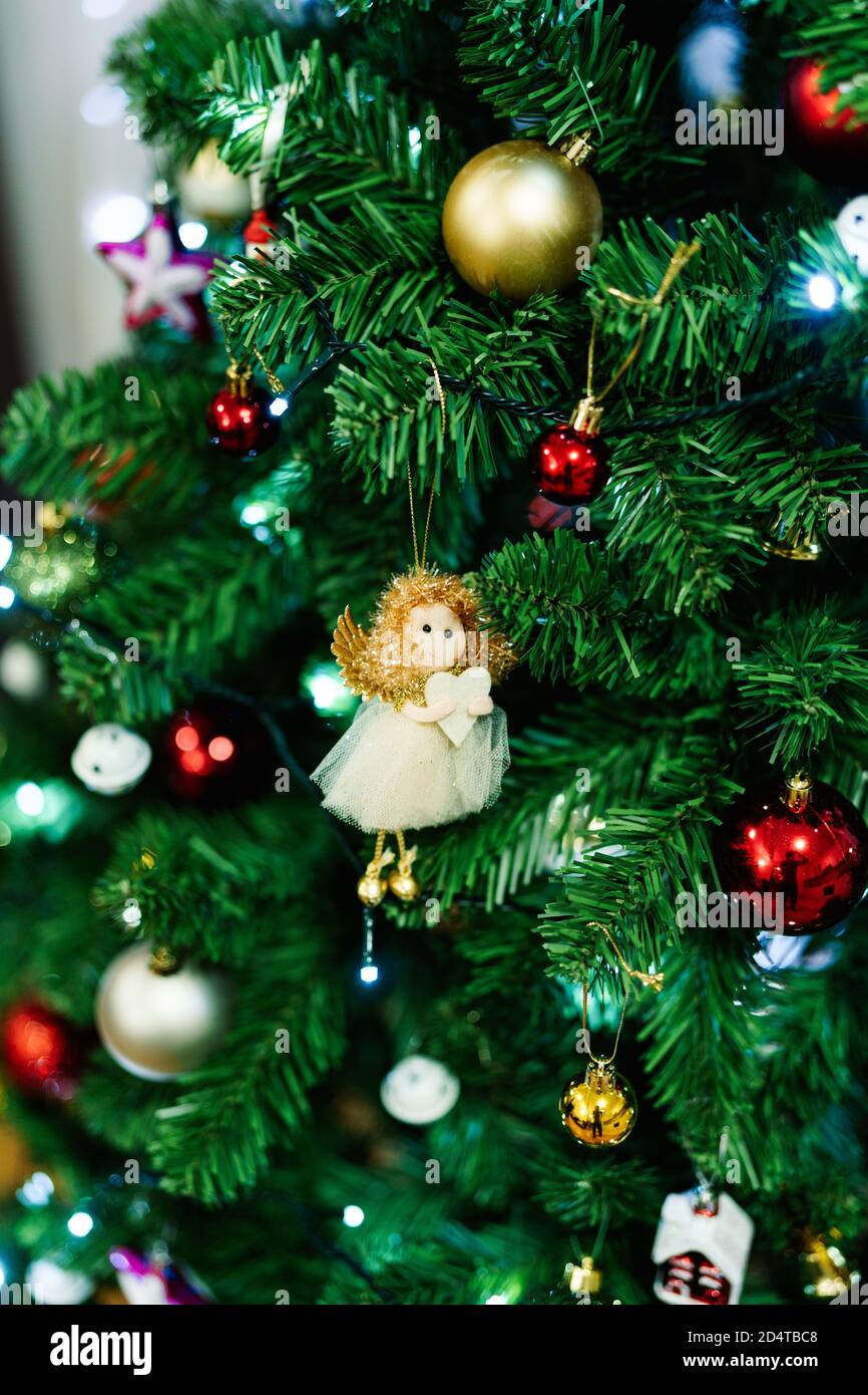 Little toy angel on the branches of a Christmas tree Stock Photo - Alamy