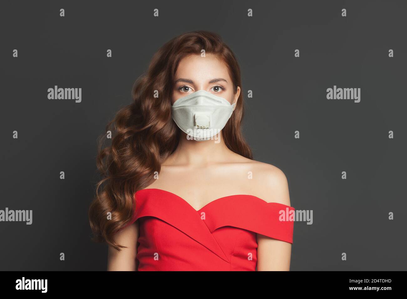 Beautiful woman in protective medical mask on black background Stock ...